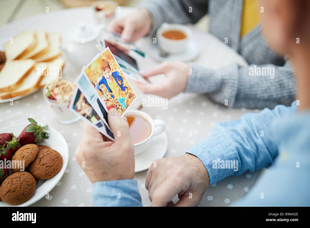 Looking through photos Stock Photo - Alamy