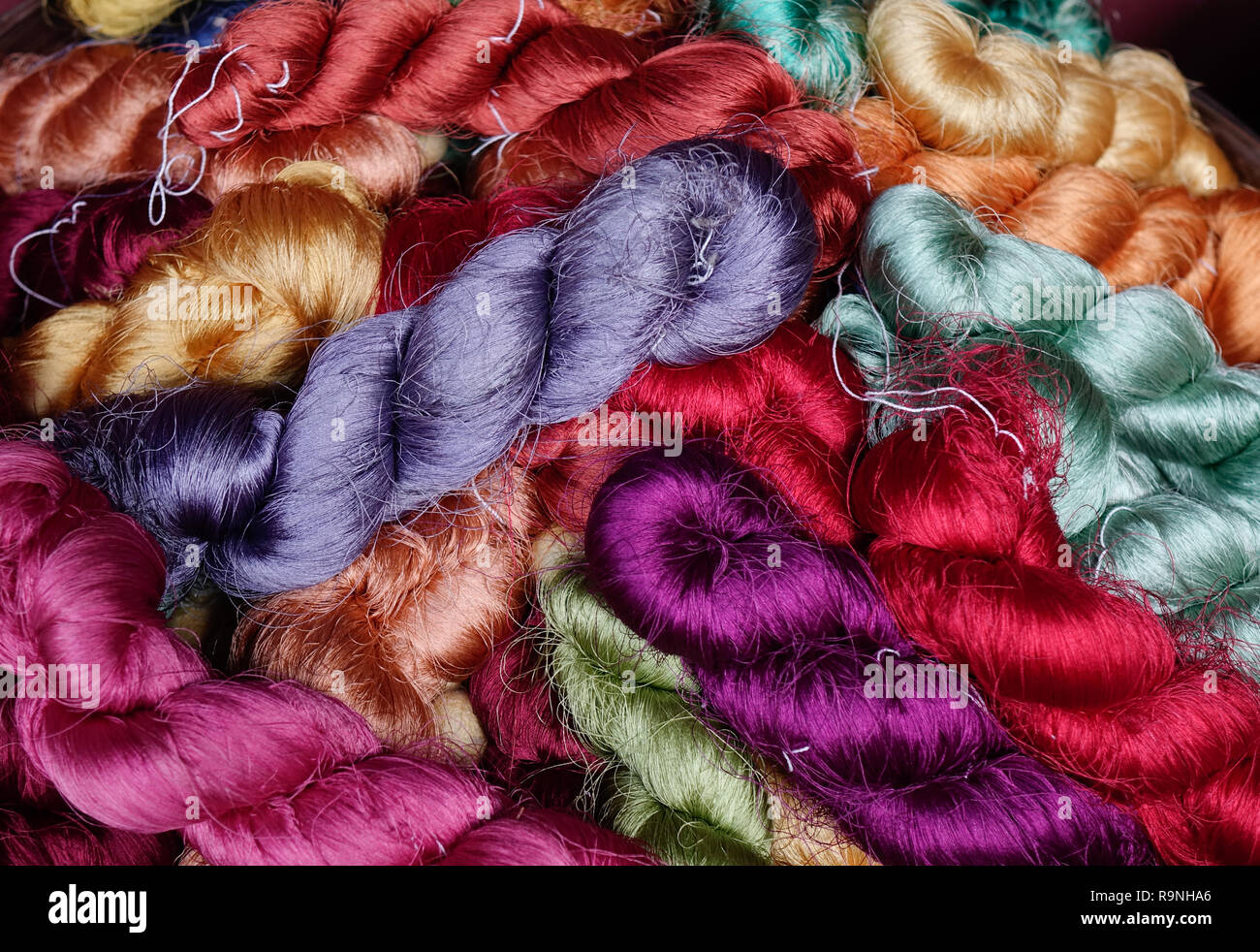 Colorful threads of Thai silk in a basket closeup for background Stock ...