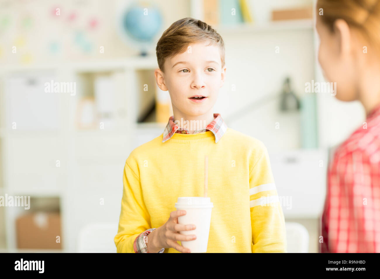 Boy talking to classmate Stock Photo - Alamy