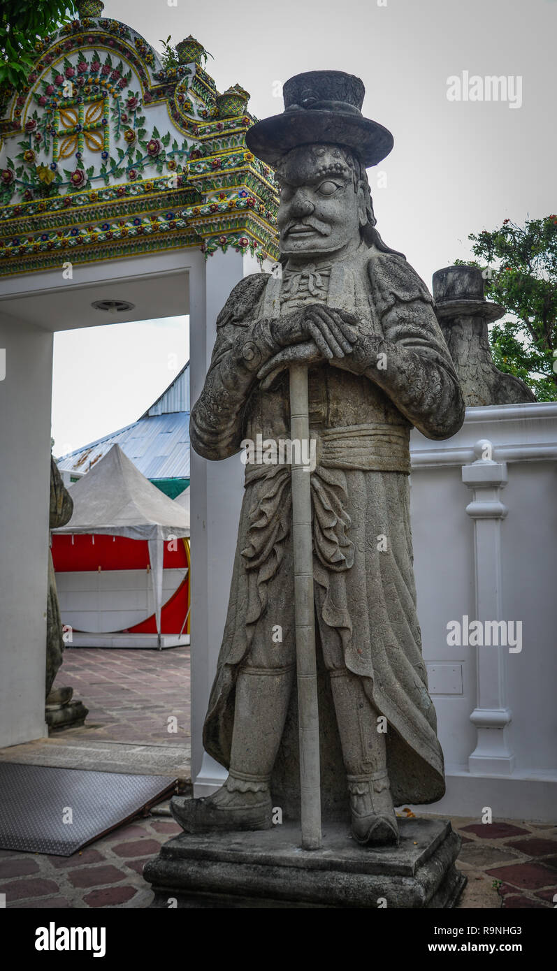 Chinese guardian figure beside a gate in Wat Pho. Wat Pho is one of the ...