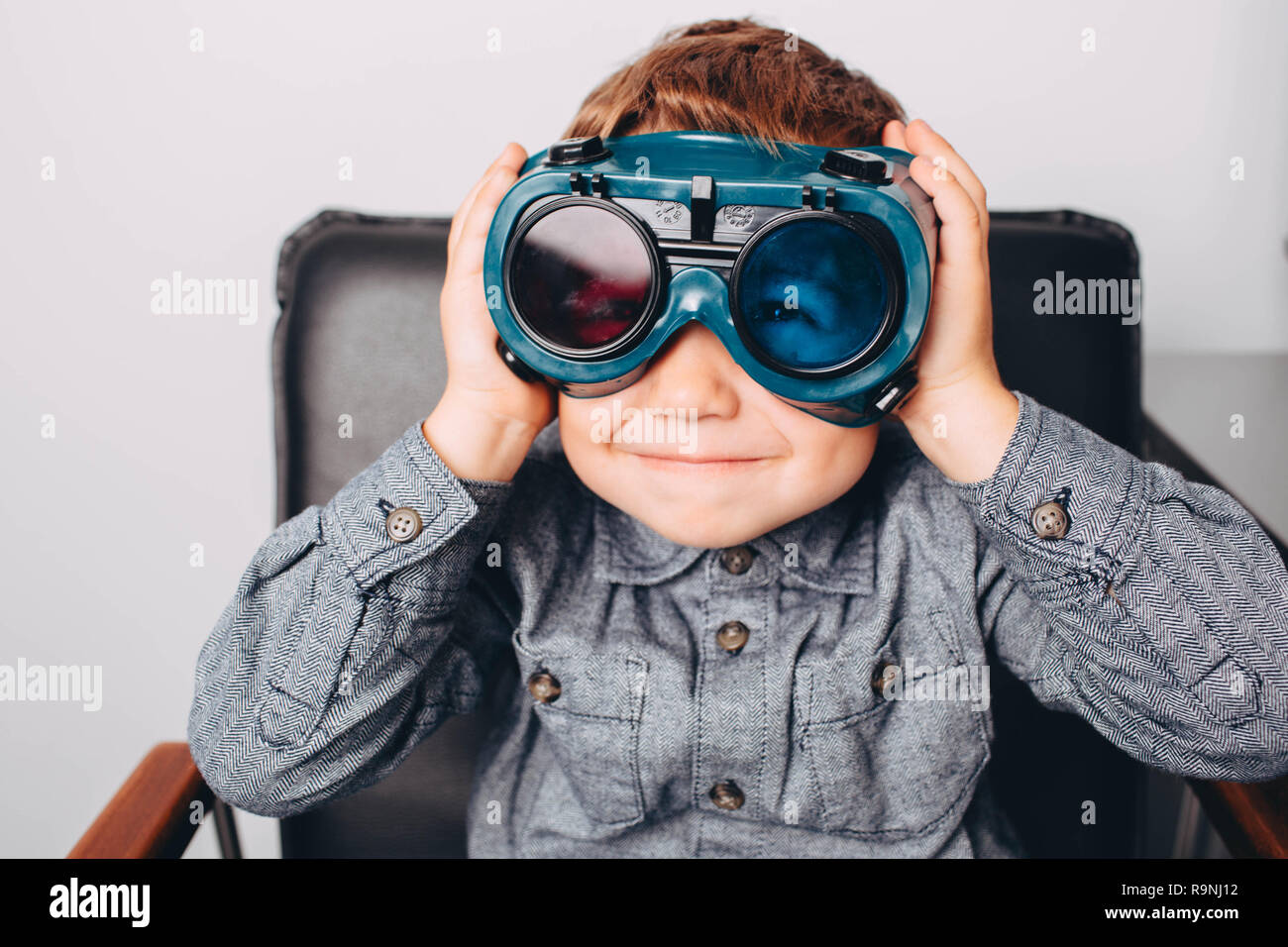 Happy boy receiving eye exam at clinic, eyesight examination children ...