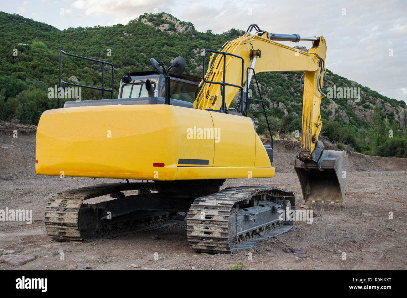 Yellow excavator at construction site Stock Photo - Alamy