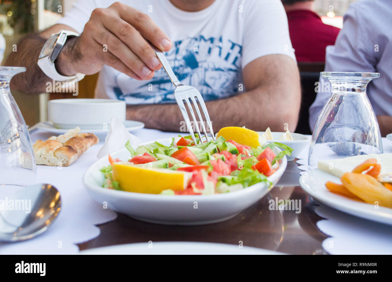 Man eating salad in restaurant Stock Photo - Alamy