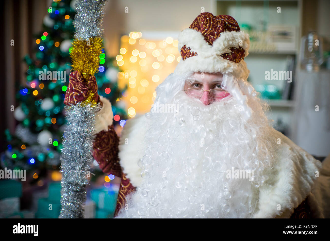 Portrait of Santa Claus in a red suit on the background of the ...