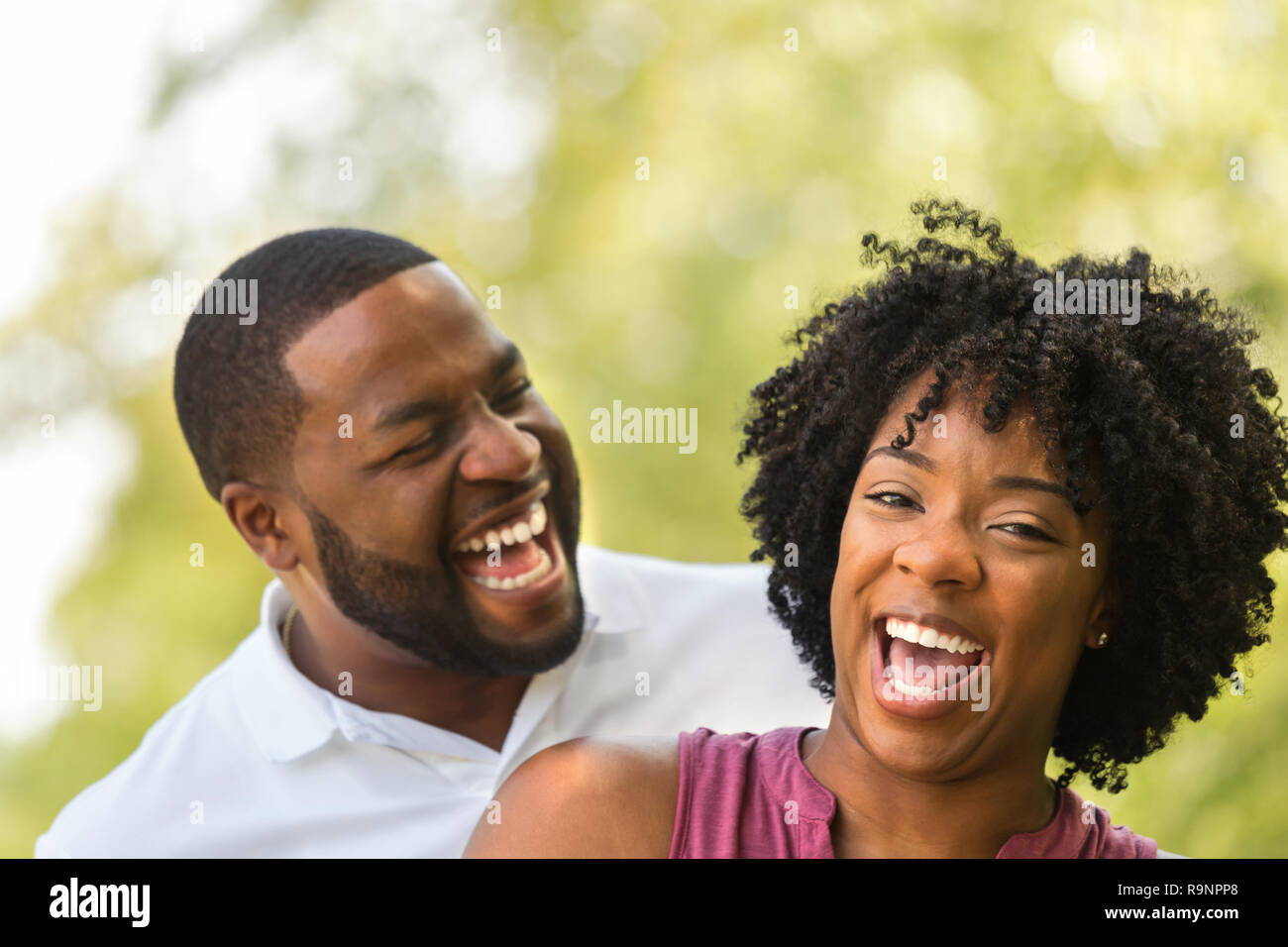 Happy African American couple laughing and smiling Stock Photo - Alamy