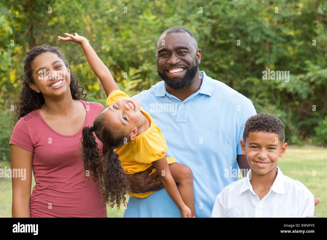Portarit of a happy dad laughing and smiling with his children Stock ...