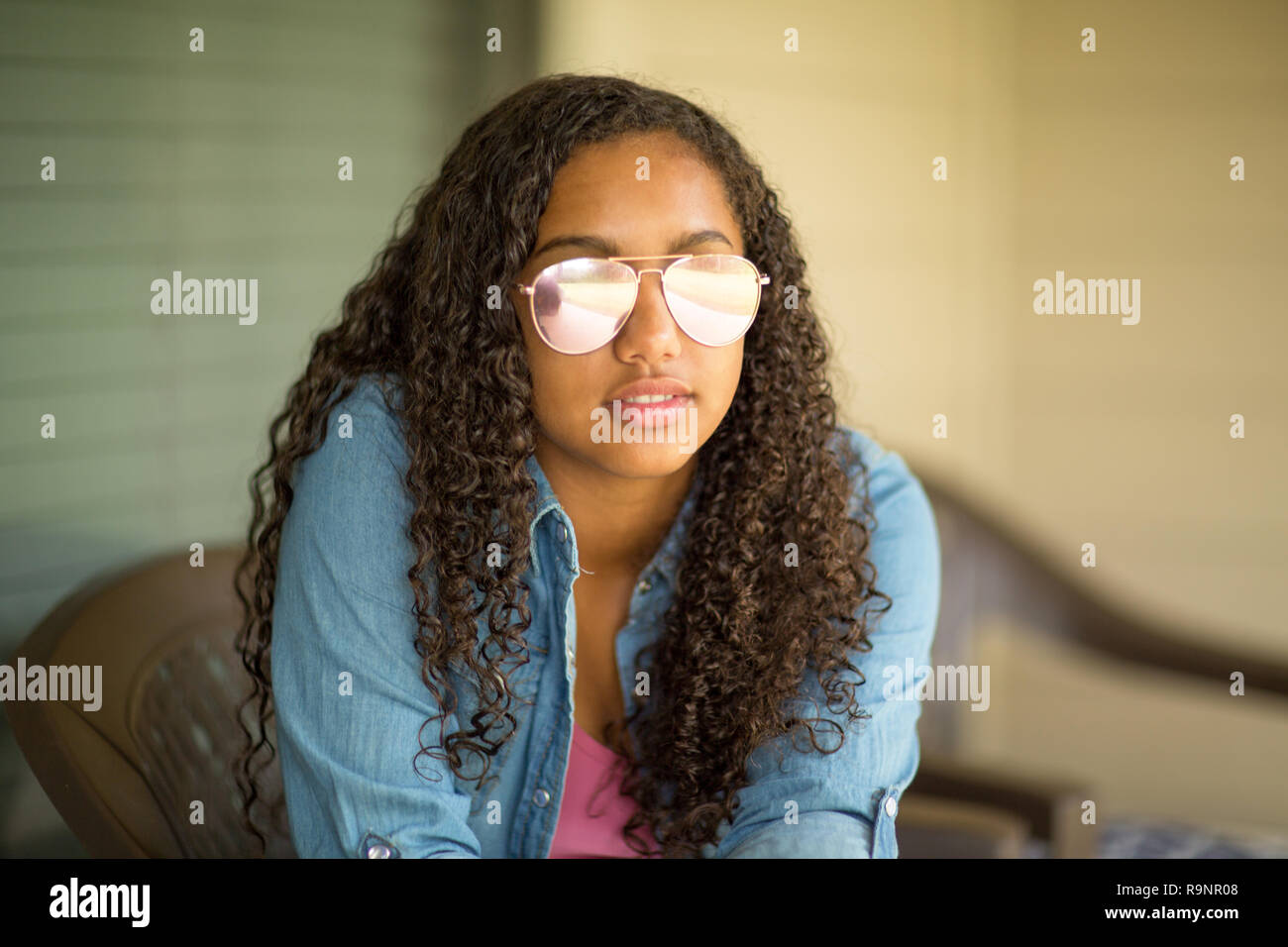 Young teenage girl in deep thought sitting outside Stock Photo - Alamy