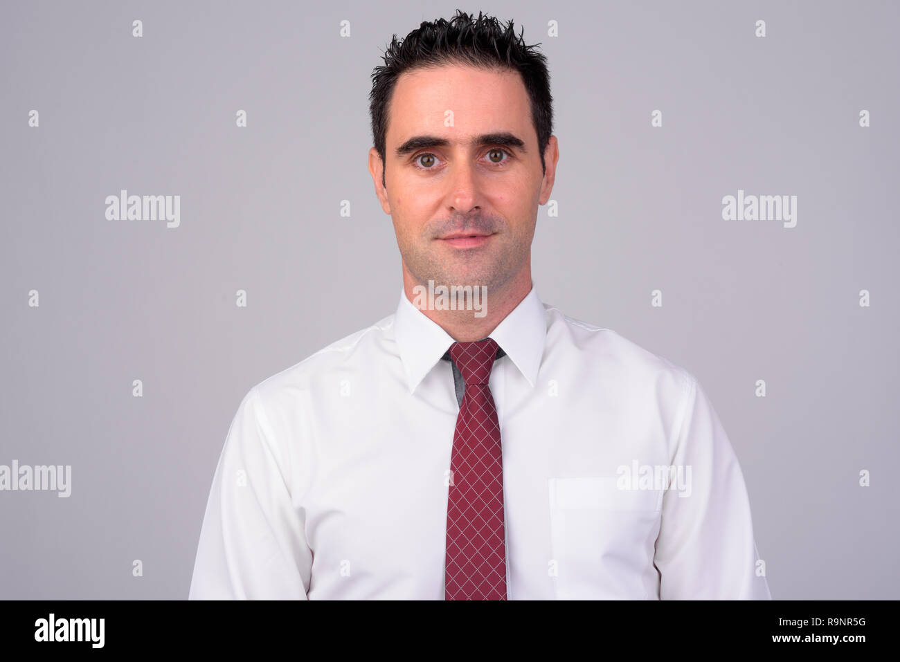 Face of handsome businessman against white background Stock Photo - Alamy