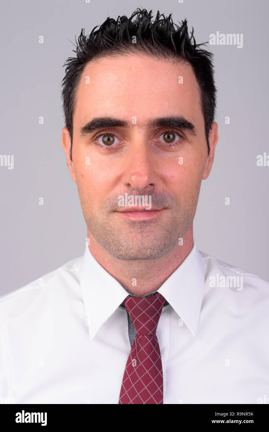 Face of handsome businessman against white background Stock Photo - Alamy