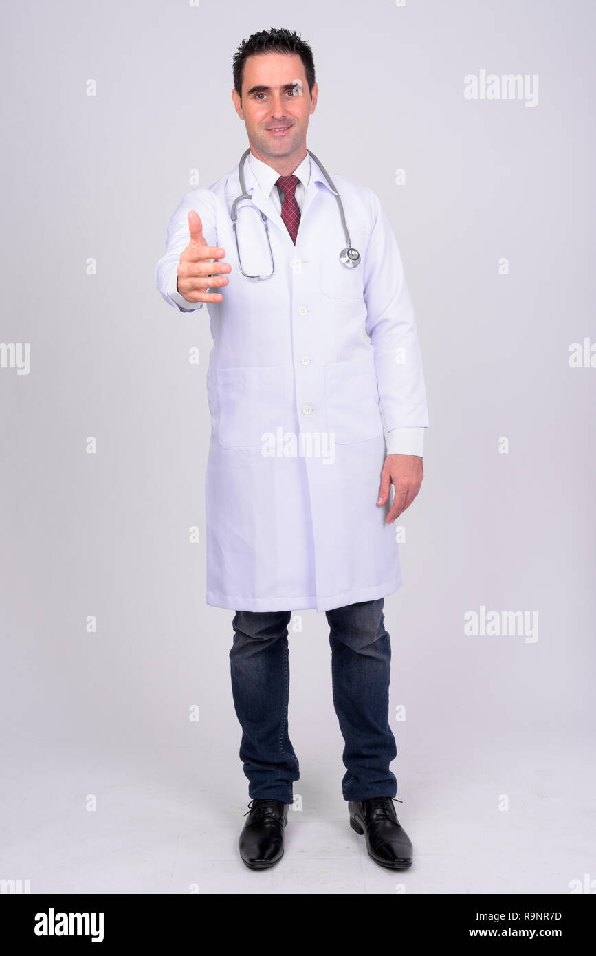 Full body shot of happy man doctor giving handshake against white ...