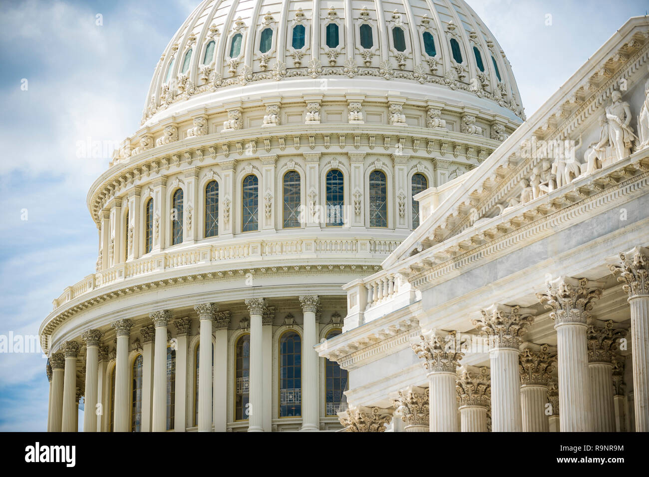Sunny detail view of the neoclassical architecture of the US Capitol ...