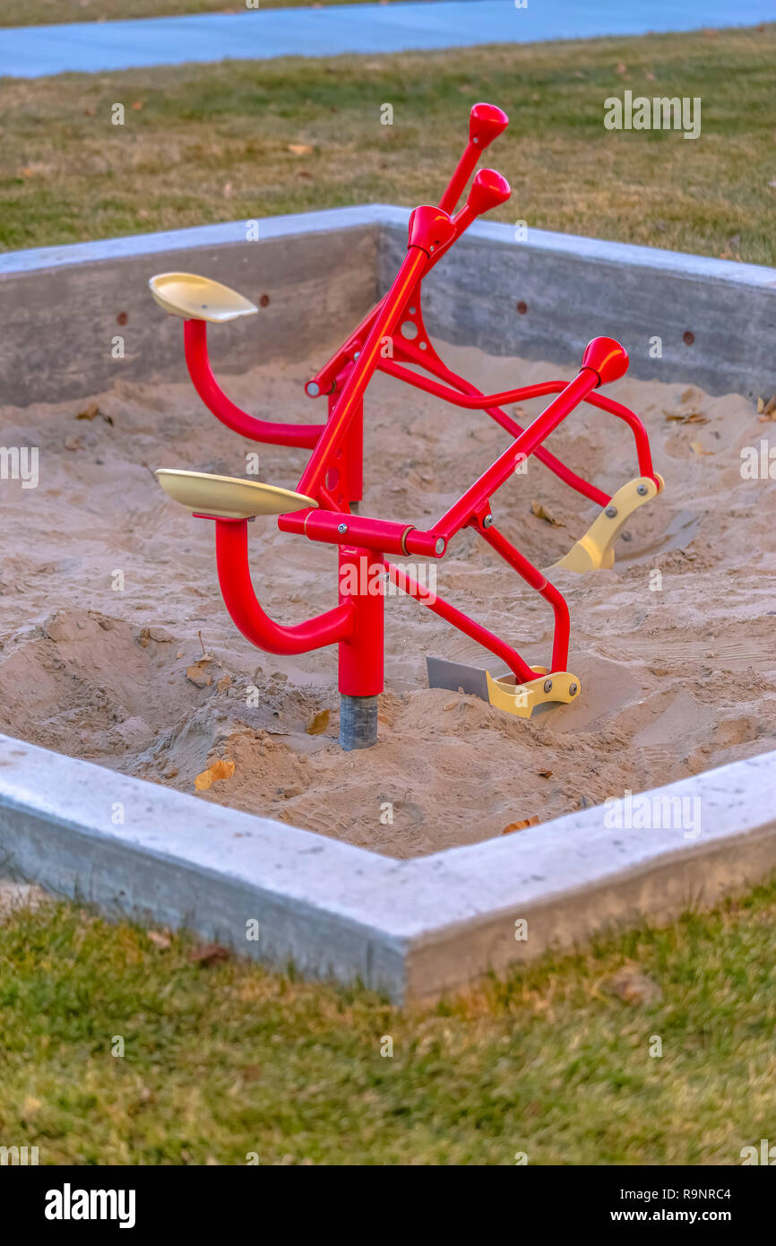 Red digging toys in playground in Utah Valley Stock Photo - Alamy