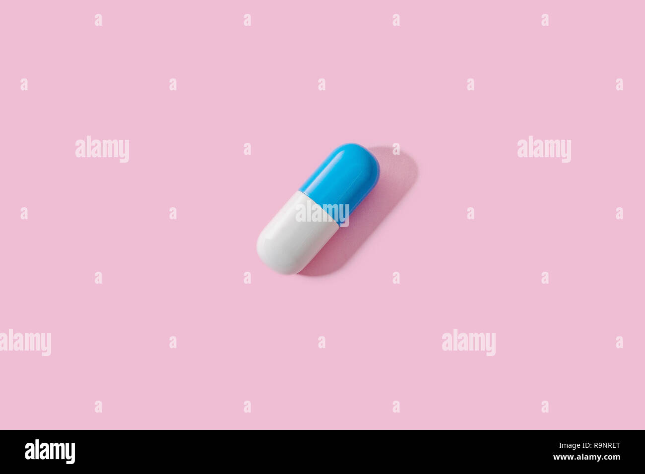 Blue pill. Pink background Stock Photo - Alamy