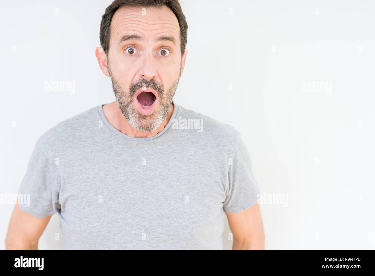 Handsome senior man over isolated background afraid and shocked with ...