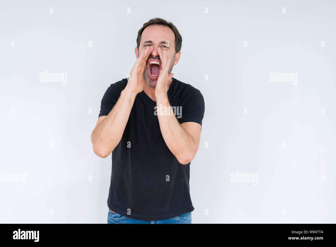 Senior man over isolated background Shouting angry out loud with hands ...