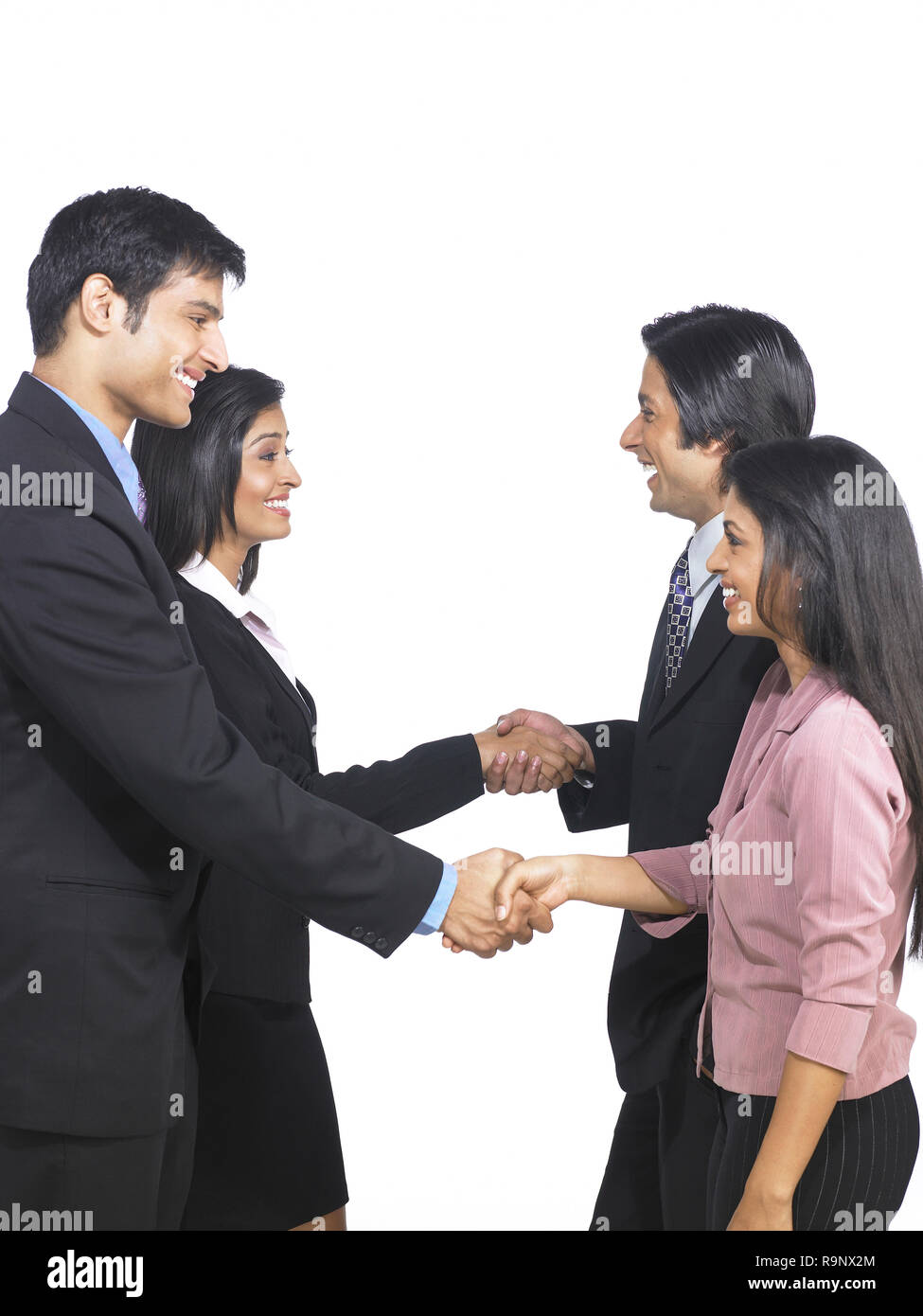 PORTRAIT OF FOUR CORPORATE EXECUTIVES SHAKING HANDS Stock Photo - Alamy