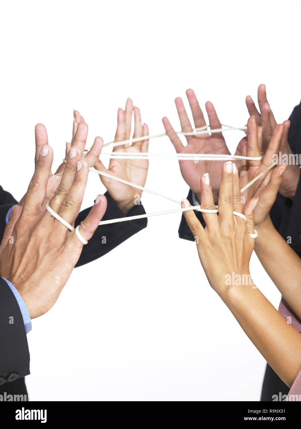 PORTRAIT OF FOUR CORPORATE EXECUTIVES HANDS ENTWINED WITH ROPES Stock ...