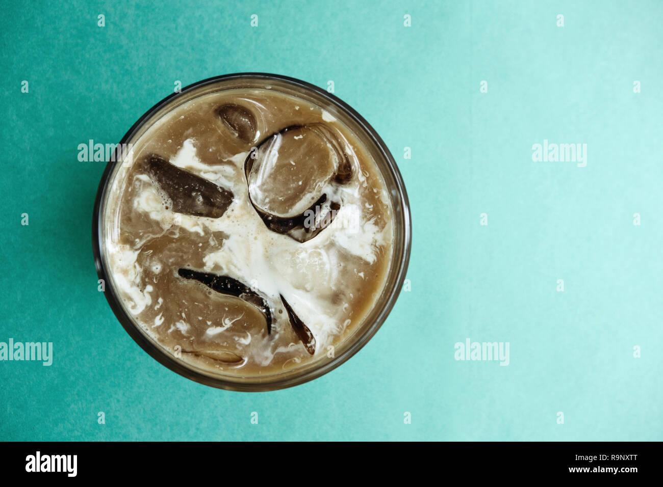 Top view close-up on aromatic fresh iced coffee on a green background ...