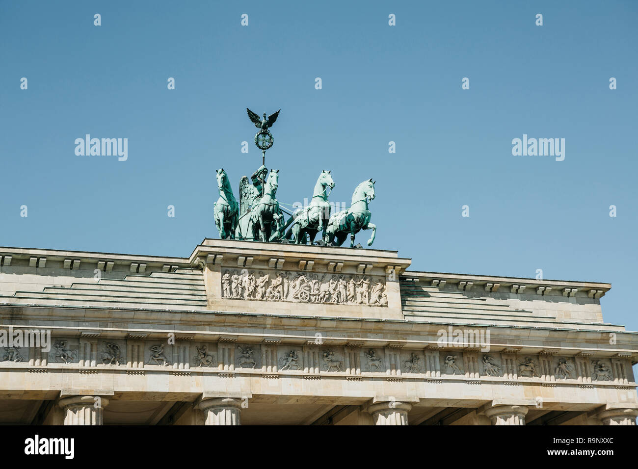 Closeup of the Brandenburg Gate against the blue sky. This is one of ...