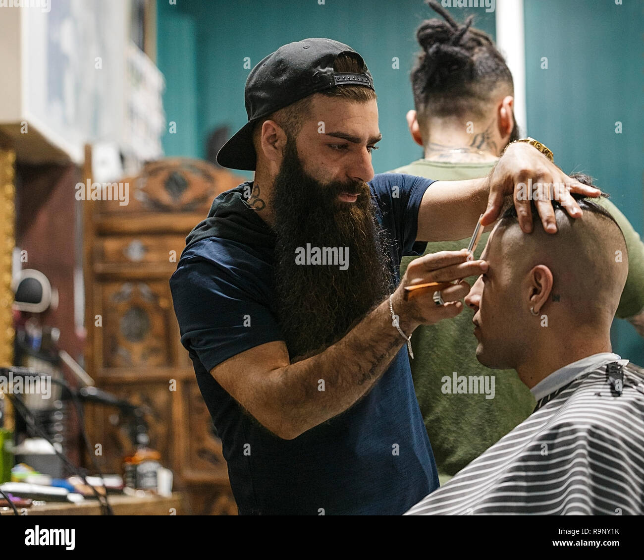 Brisbane, Australia-October 02,2018: Hipster hairdresser serves his ...