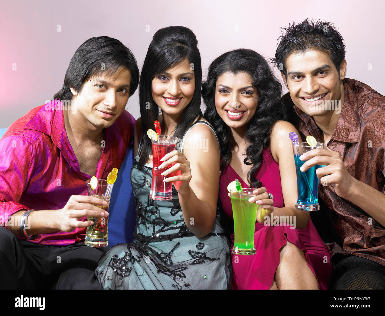 TWO YOUNG COUPLES ENJOYING IN A PARTY Stock Photo - Alamy