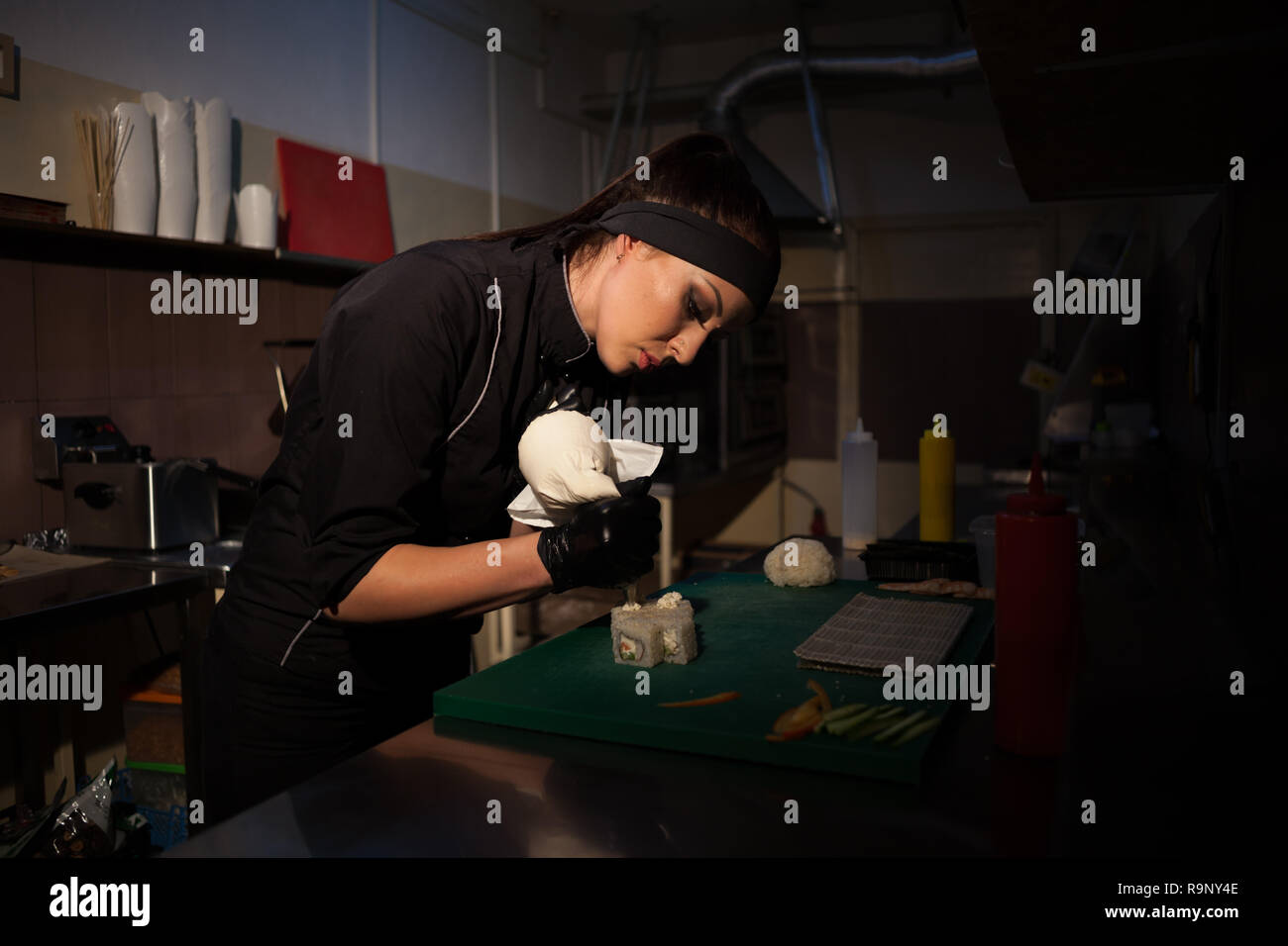 woman chef prepares fresh sushi in the kitchen of the restaurant Stock ...