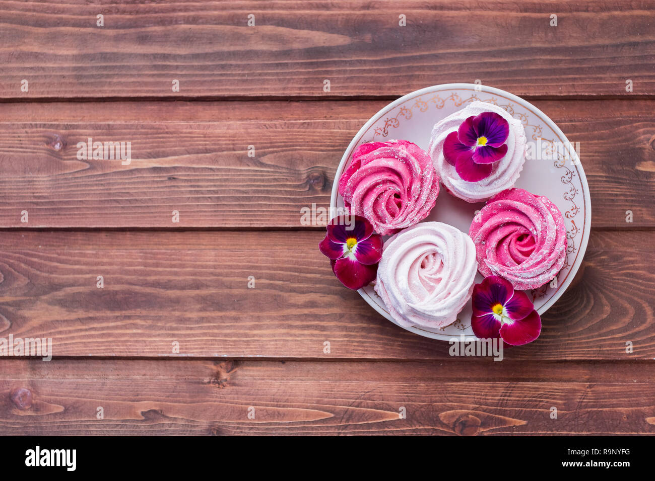 Homemade pink marshmallow from currant on a wooden background with pink ...