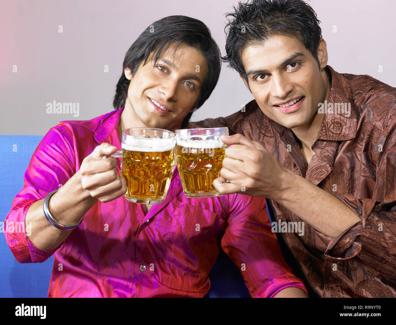 PORTRAIT OF TWO YOUNG YOUNG MEN DRINKING A BEER Stock Photo - Alamy