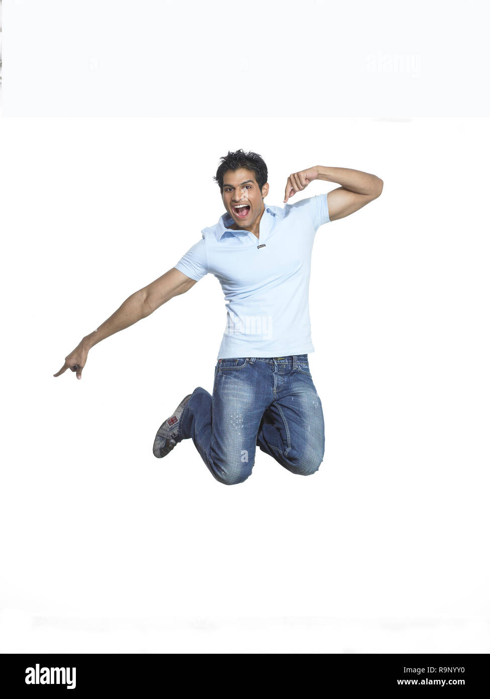 YOUNG MAN JUMPING IN EXUBERANCE AGAINST A WHITE BACKGROUND Stock Photo ...