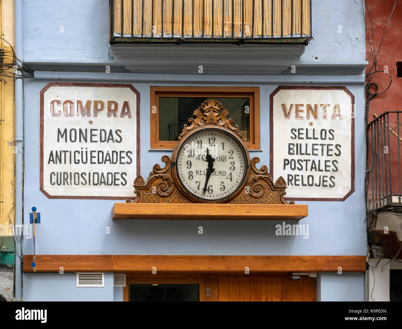 VALENCIA, SPAIN - MAY 24, 2018: Signage and clock on shop in the city ...