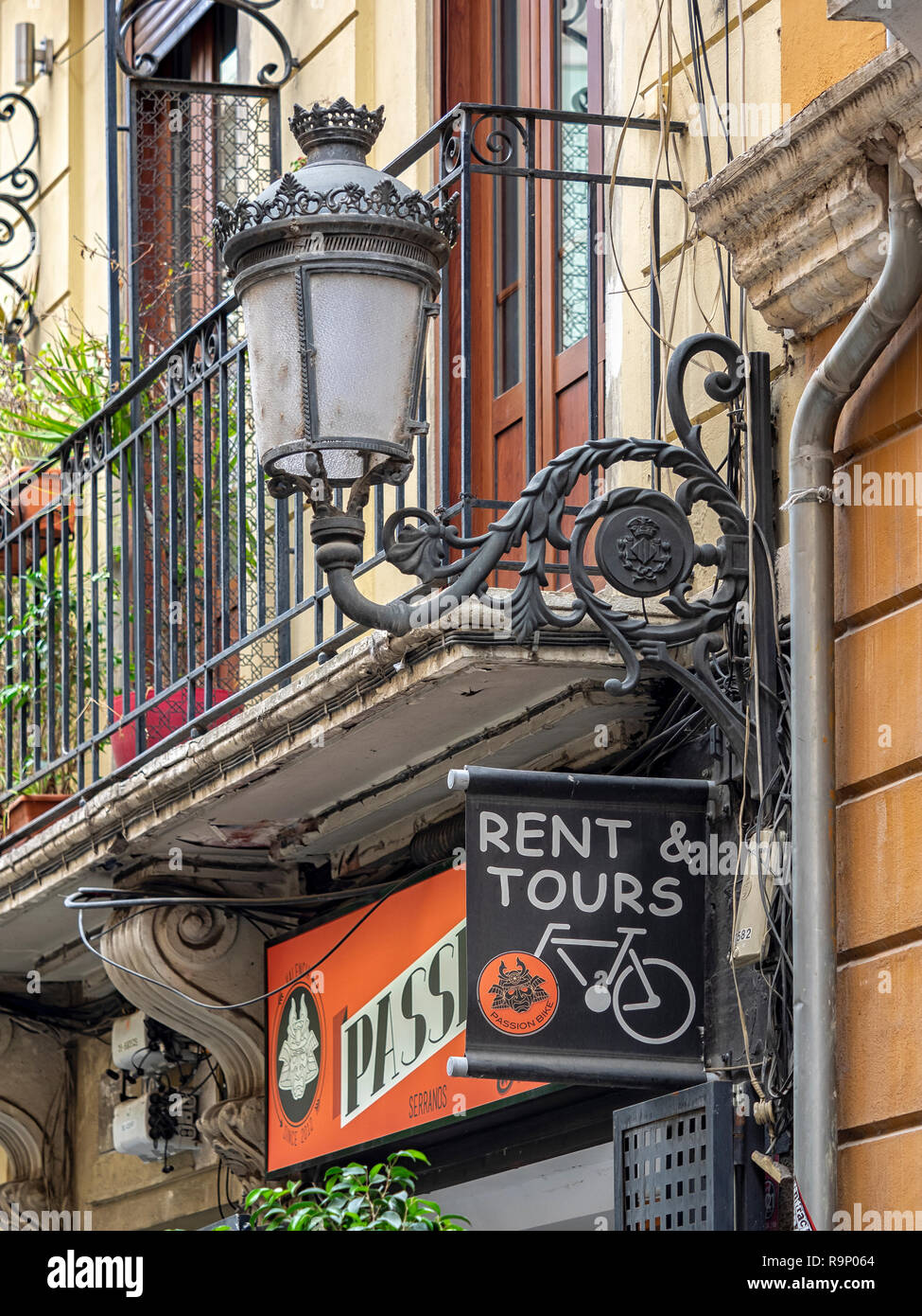VALENCIA, SPAIN - MAY 24, 2018: Vintage Lamp and Cycle Rental Sign ...