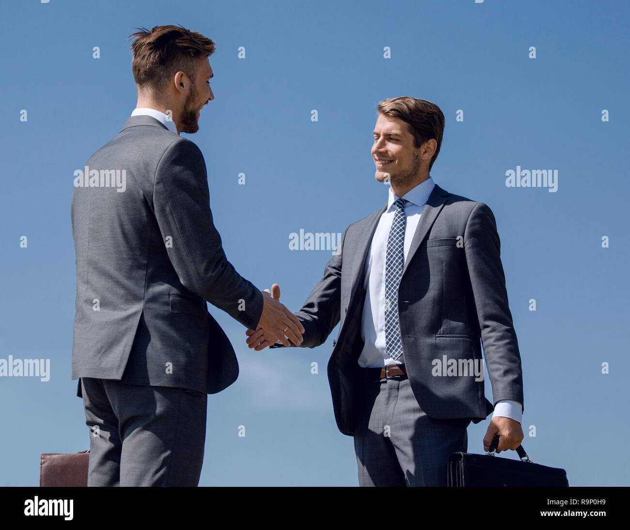business people greet each other with a handshake Stock Photo - Alamy