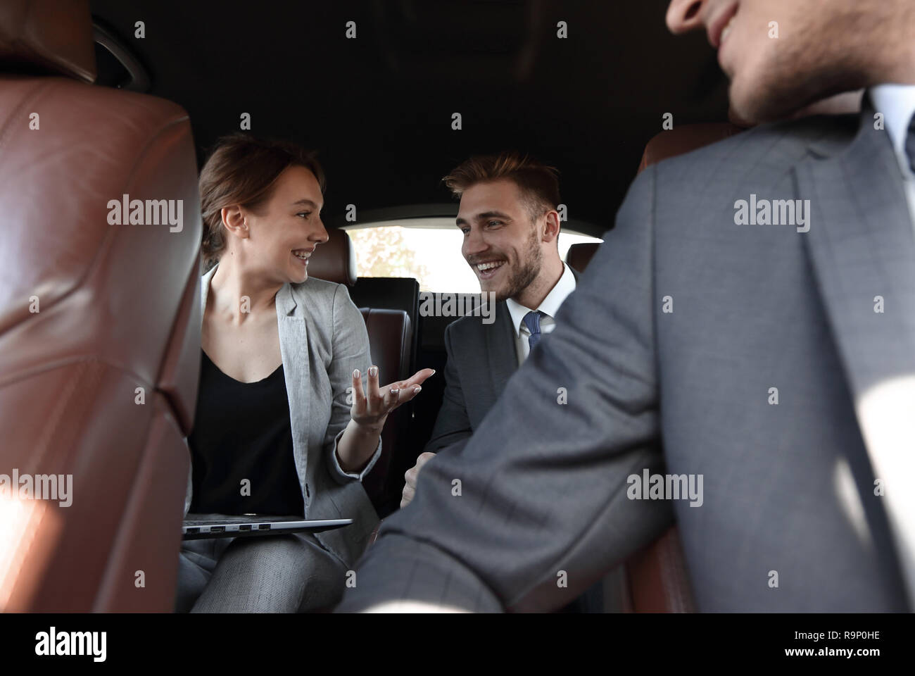 business colleagues are discussing something sitting in the car Stock ...