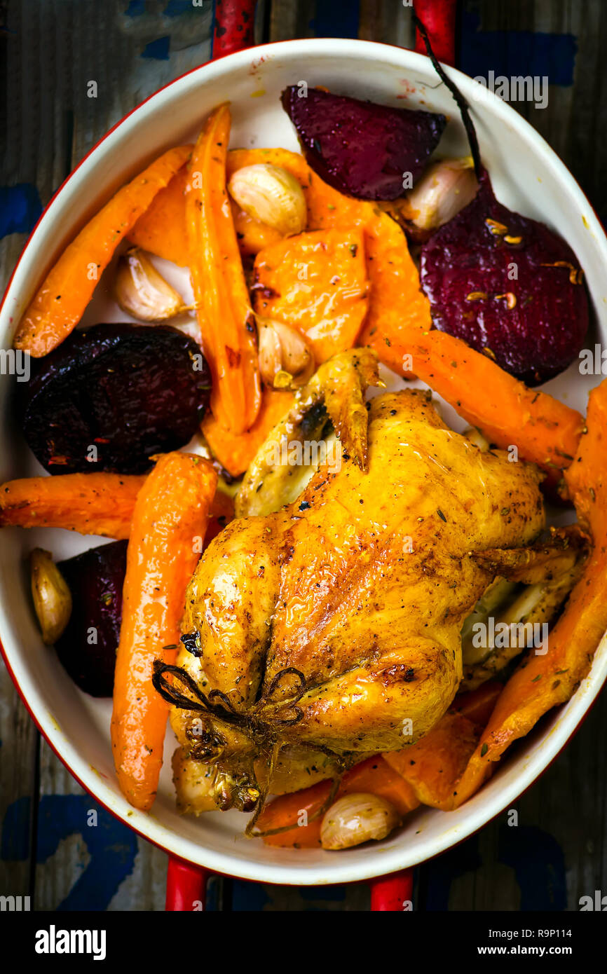 The chicken baked with root crops. top view. selective focus Stock ...