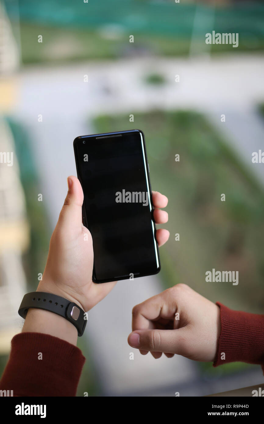 Boy is holding smartphone in hand Stock Photo - Alamy