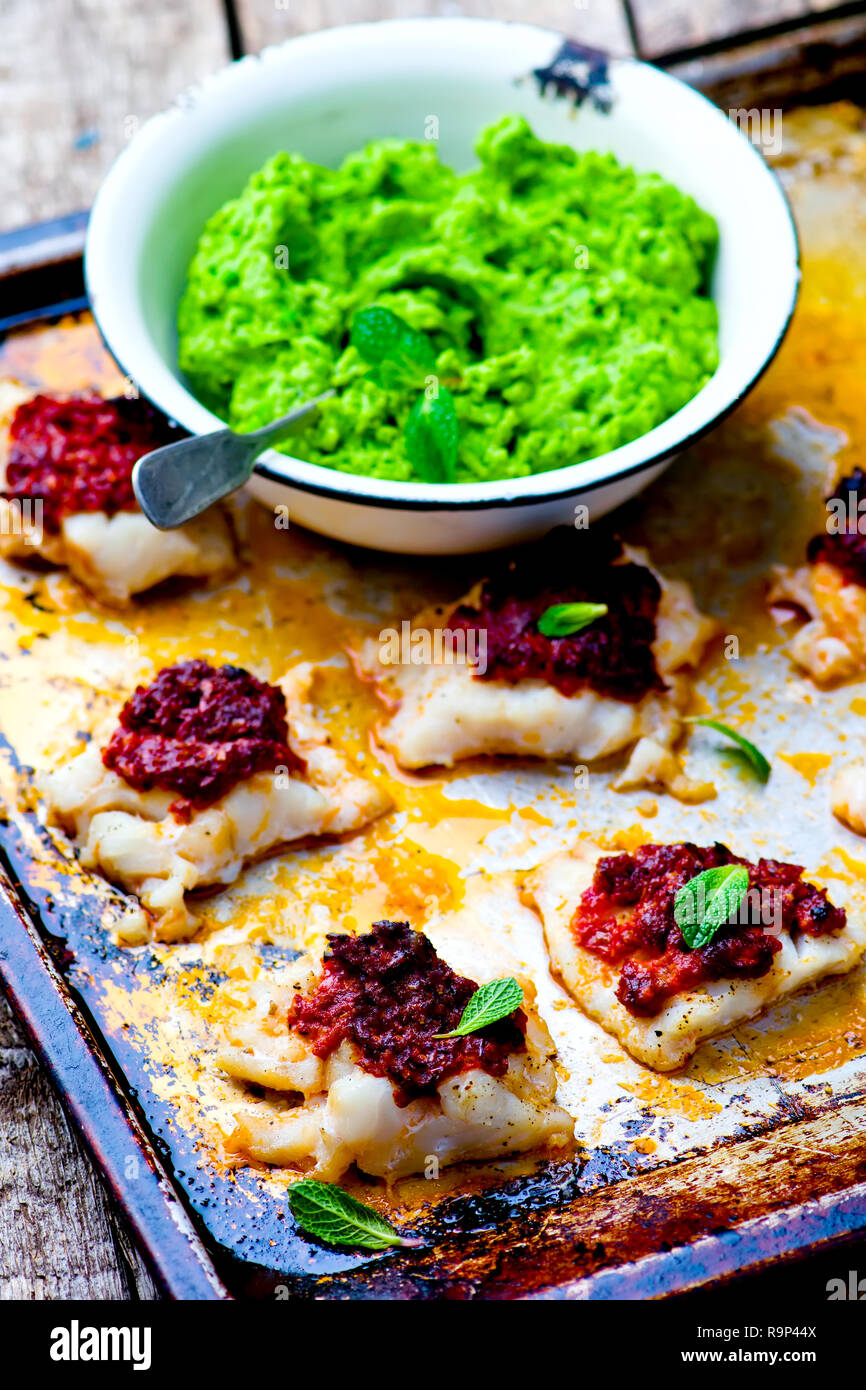 the baked cod with dried tomato and mashed green pea.selective focus ...