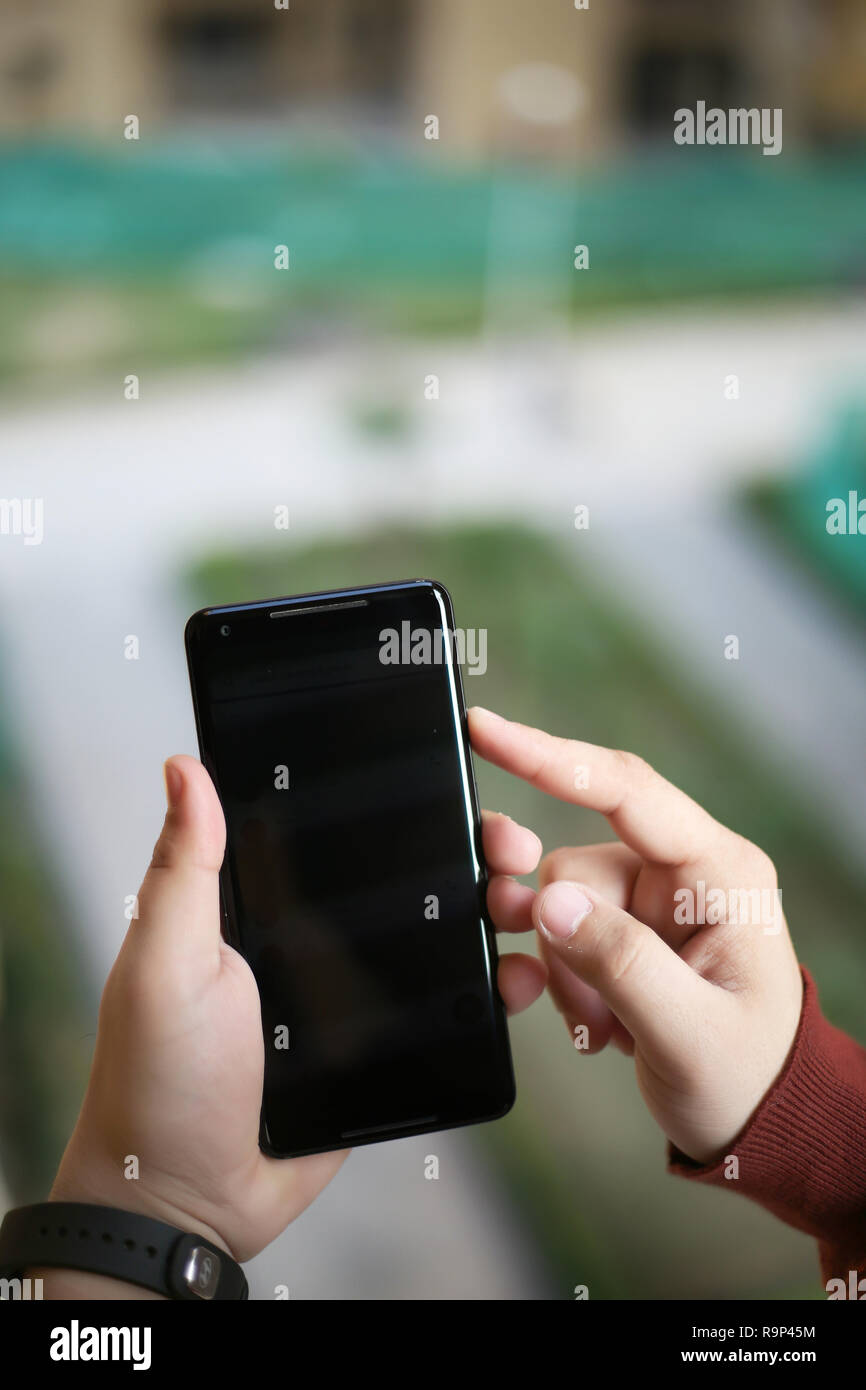 Boy is using smartphone in hand Stock Photo - Alamy