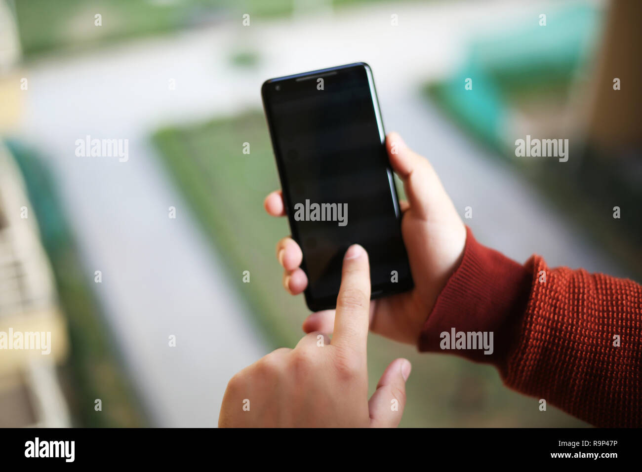 Man is using phone in hand Stock Photo - Alamy