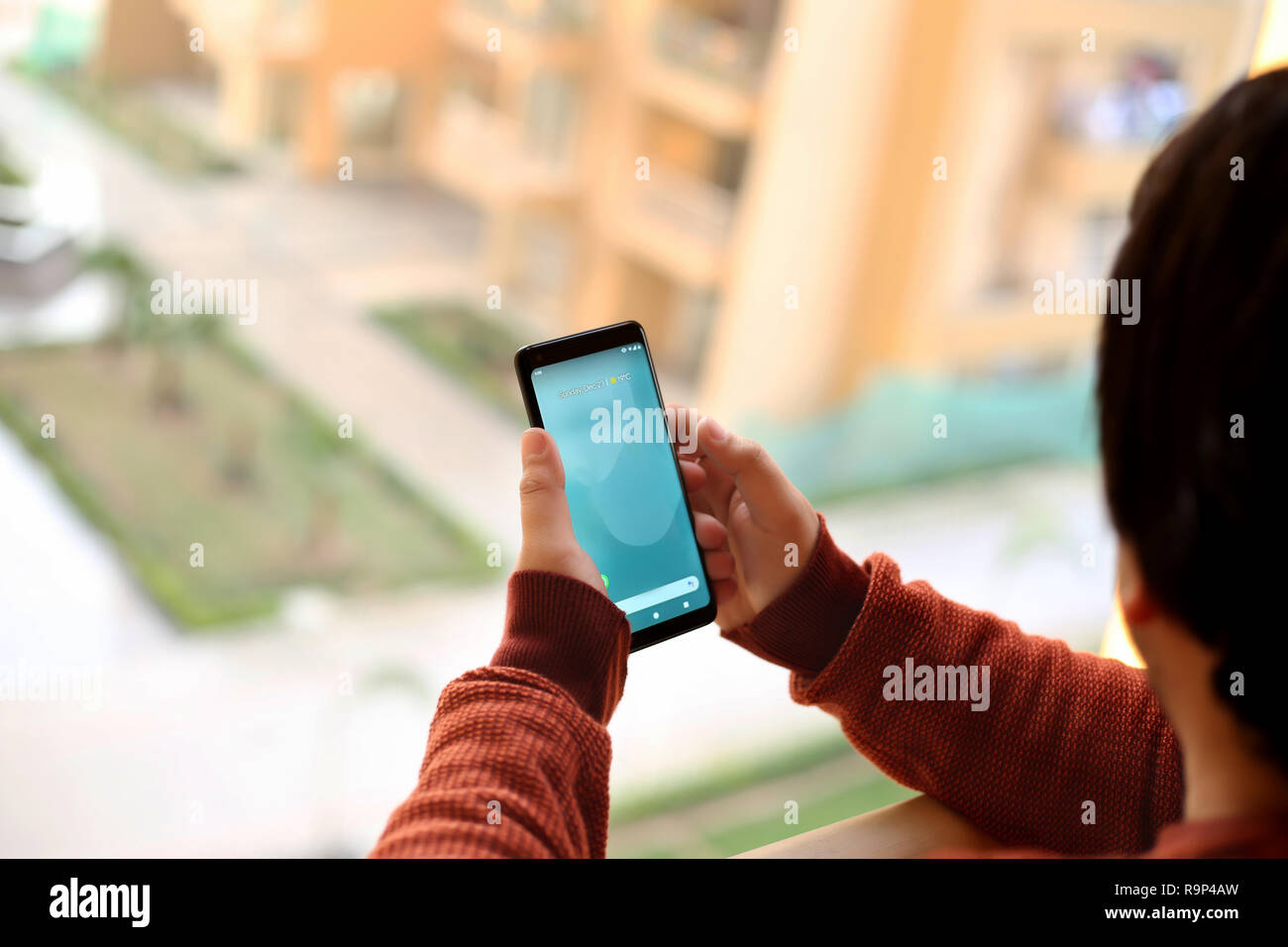 Boy is holding phone in hand Stock Photo - Alamy