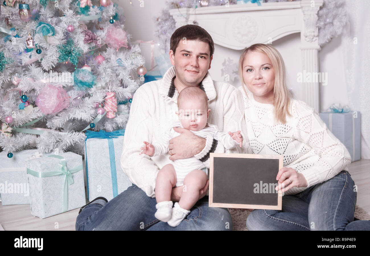 portrait of happy family in front of Christmas tree Stock Photo - Alamy