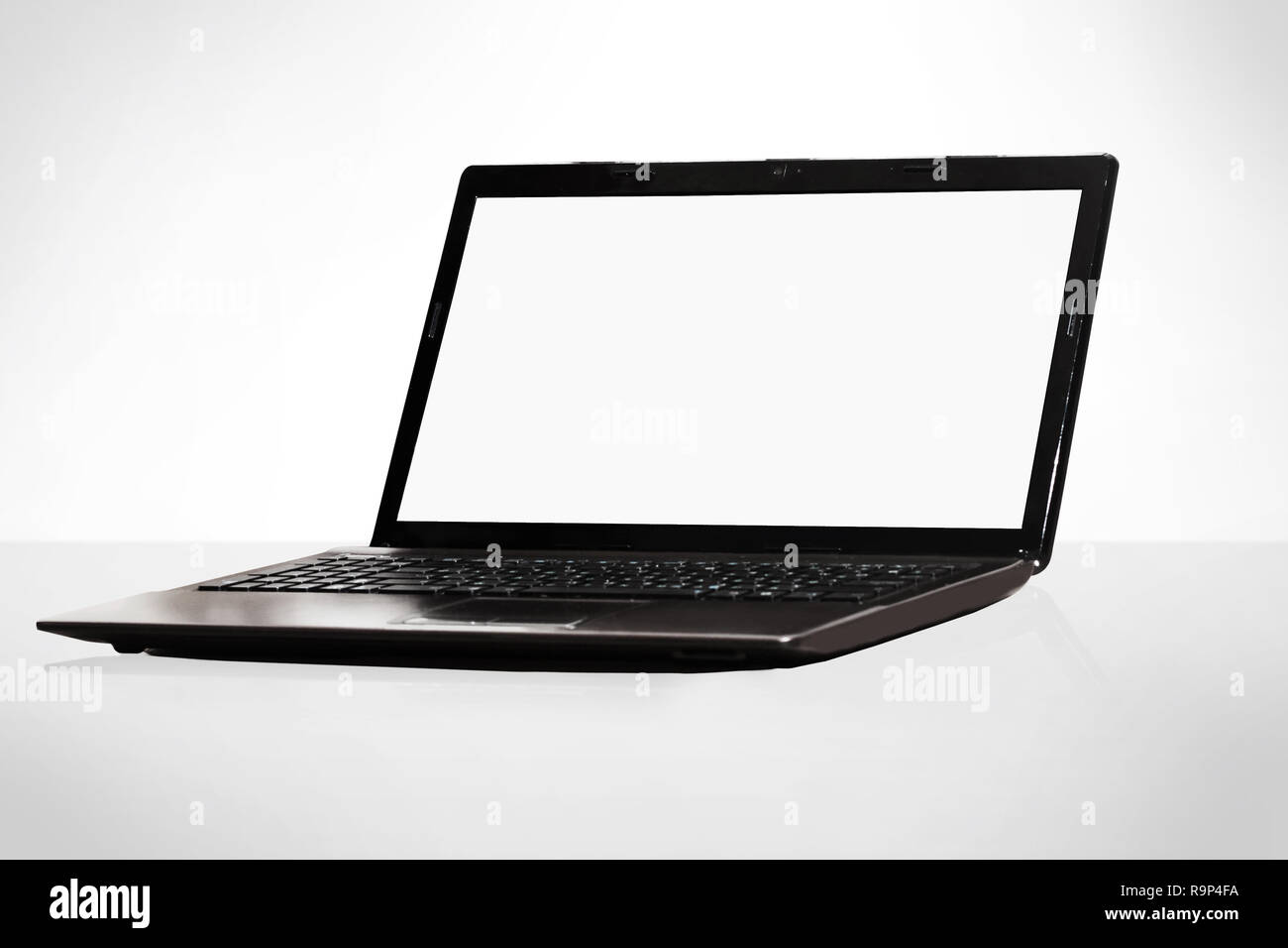 Laptop with blank white screen on a light background. Isolated on a ...