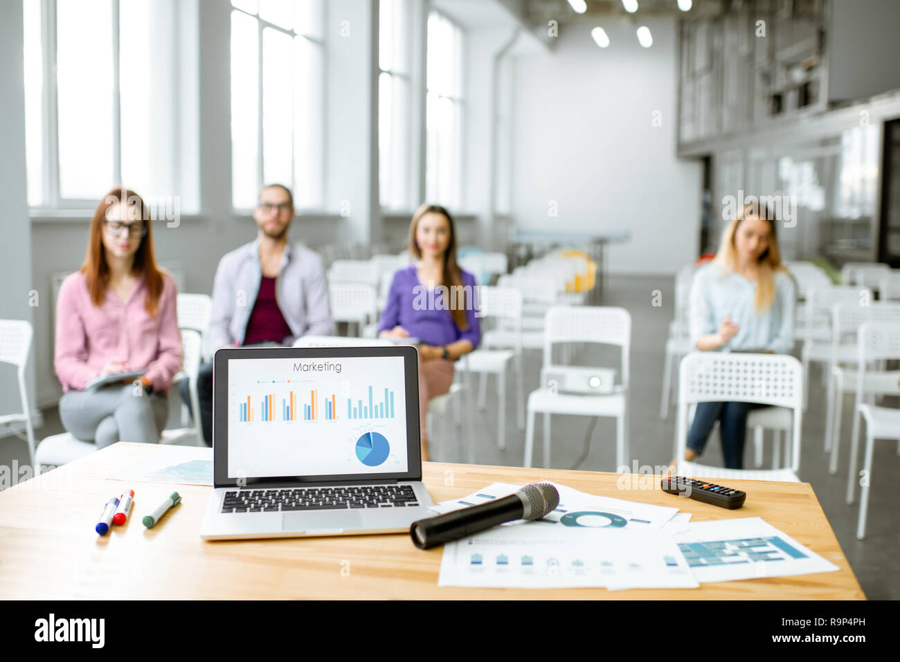 View on the laptop and papers with charts for presentation on the table ...