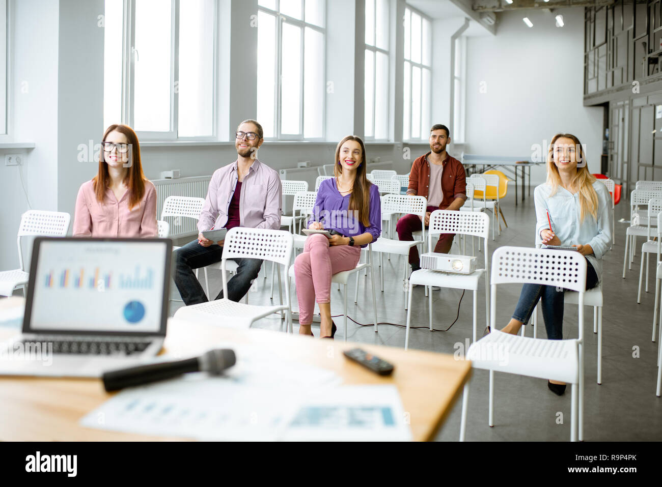 View on the laptop and papers with charts for presentation on the table ...