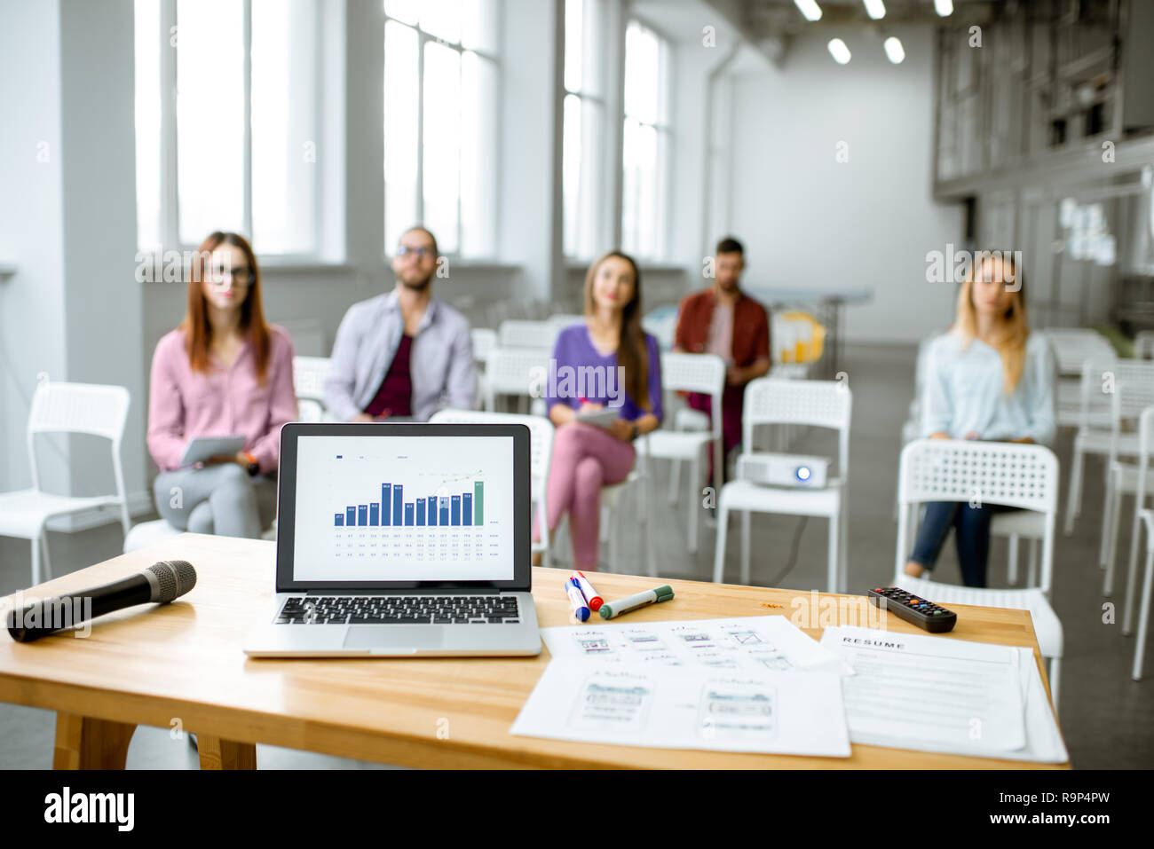 View on the laptop and papers with charts for presentation on the table ...