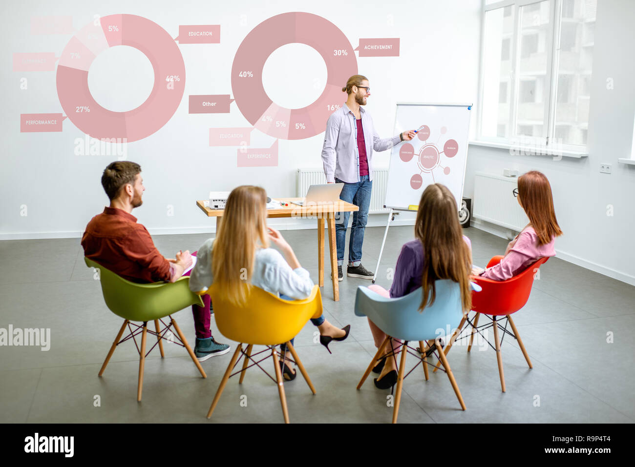 Young male speaker reporting to the audience during the meeting in the ...