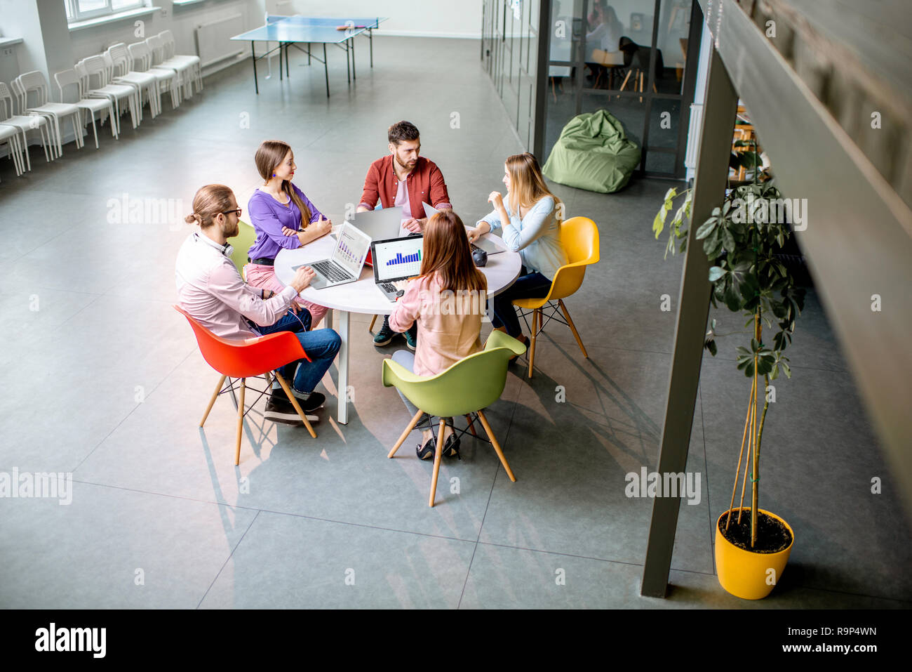 Team of a young coworkers dressed casually working together with ...