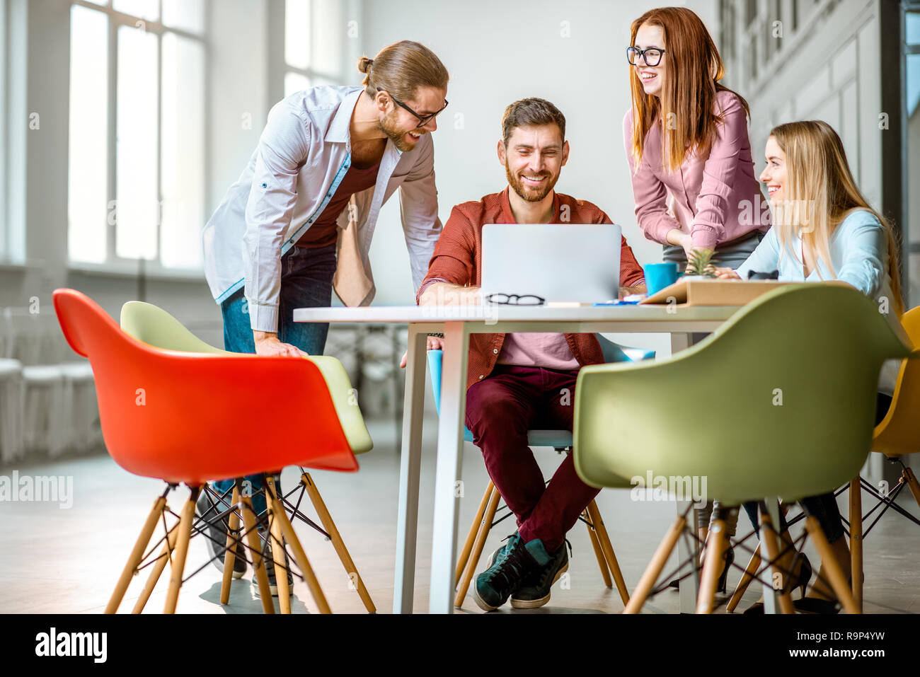 Group of a young coworkers dressed casually working together with ...