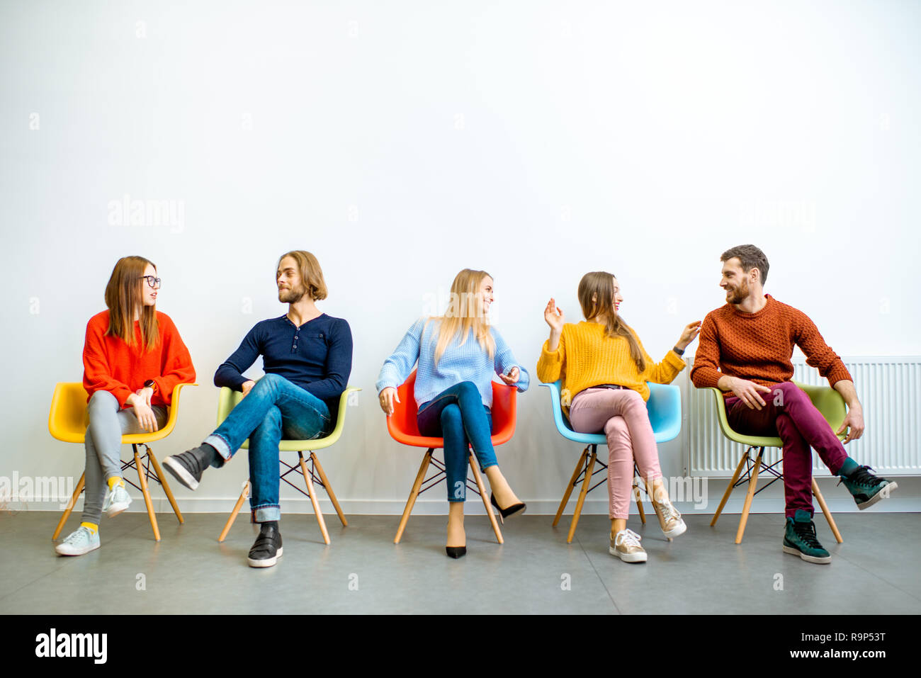 Sitting on row of chairs hi-res stock photography and images - Alamy