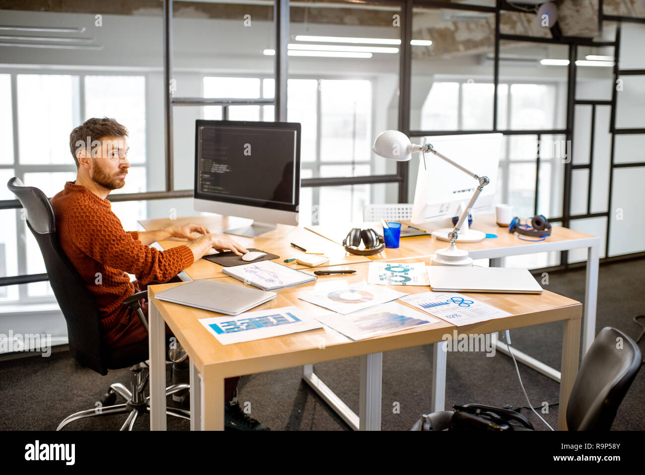 Man As A Programmer Working With Computer Code Sitting At The Beautiful Working Place In The