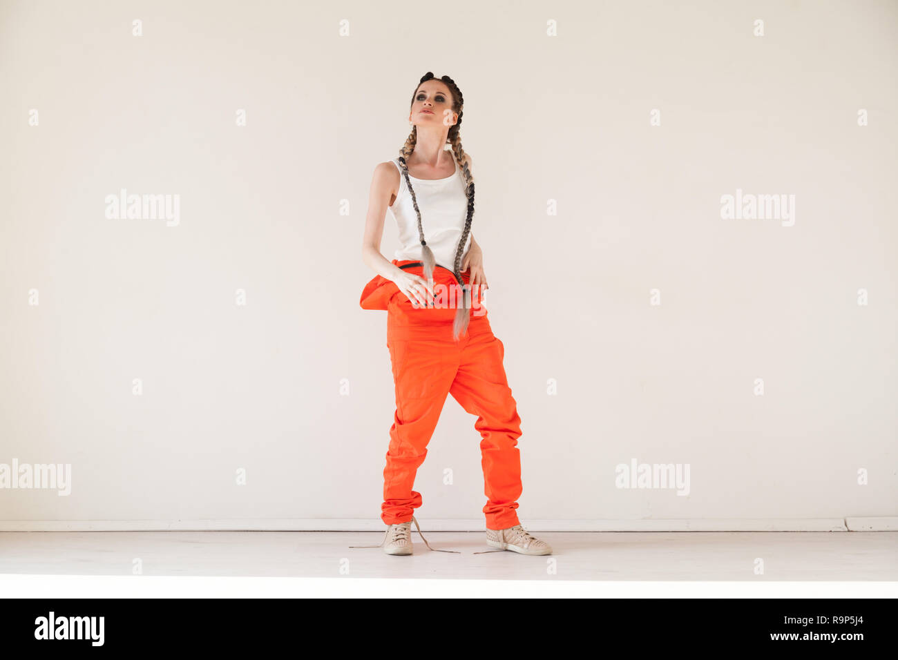 beautiful fashionable woman with braids dancing work overalls Stock ...
